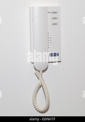 A modern intercom system with a white telephone receiver, displayed on ...