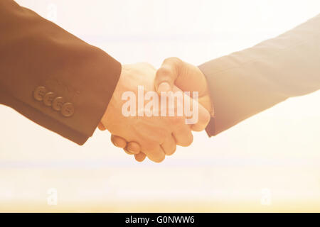 Business handshake with sun rays Stock Photo - Alamy