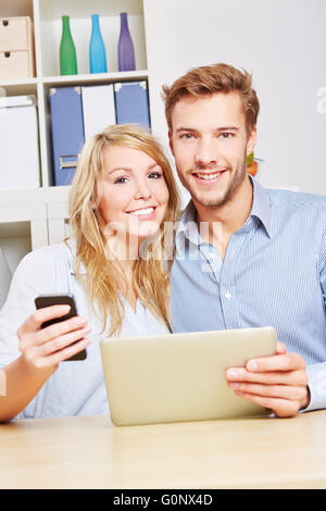 couple with tablet pc computer sitting on chairs at camping Stock Photo ...
