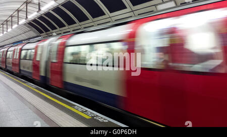 Train arrives at Angel Underground Station platform, Islington Stock ...