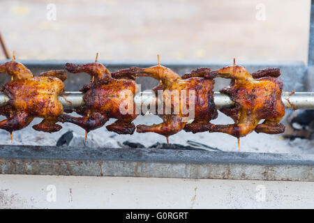 Roasting chicken on a charcoal grill Hmong Asian specialty cuisine ...