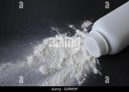 Talcum powder on black background Stock Photo - Alamy