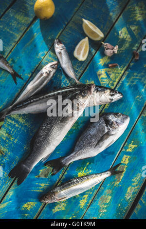 Raw fish Mackerel on a wooden cutting board. Black background. Top view ...