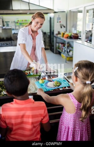 Cooker serving children Stock Photo - Alamy