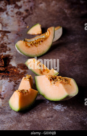 Melon slices in rusty metal background from the top Stock Photo - Alamy