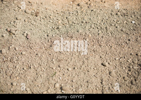 Brown lumpy soil in a shady light as a background Stock Photo - Alamy