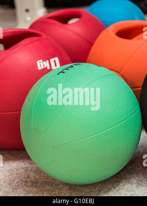 pink and blue rubber kettlebell and medicine ball on red carpet Stock ...