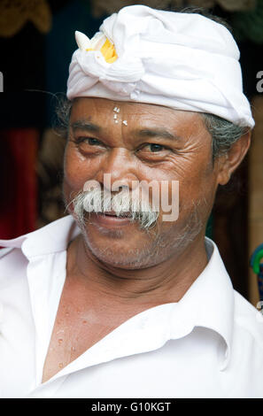 Smiling Balinese man wearing the traditional udeng head dress at a ...