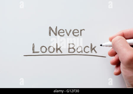 Human hand writing never look back on whiteboard Stock Photo - Alamy