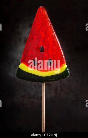 Lollipop in shape of watermelon slice on blue background Stock Photo ...