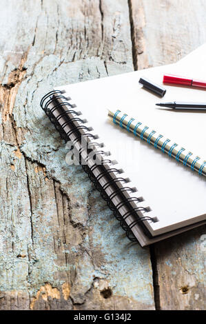 Notepads pen on wooden board office concept Stock Photo - Alamy