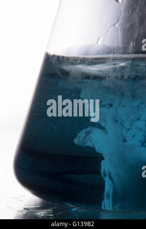 Erlenmeyer flask close up with chemical reaction fizzing Stock Photo ...