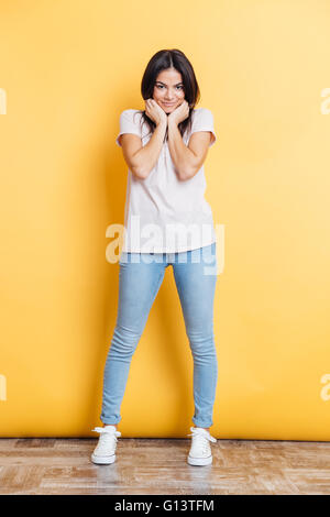 Girl isolated on yellow background Stock Photo - Alamy