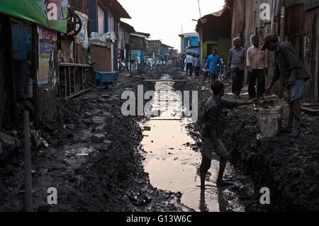 a clean up process a side street in a slum area of the kurla district ...