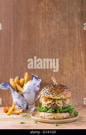 beef burger on a plate with potatoes and sauce Stock Photo - Alamy