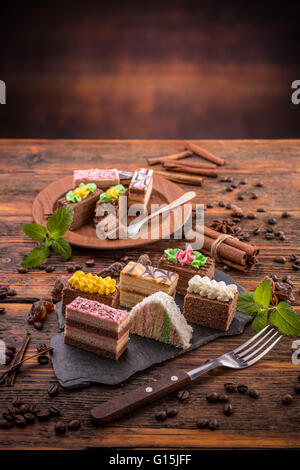Assorted cakes on wooden table background Stock Photo - Alamy