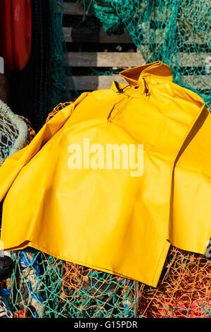Trawlerman's protective oilskin smock, and fishing gear in the harbour ...
