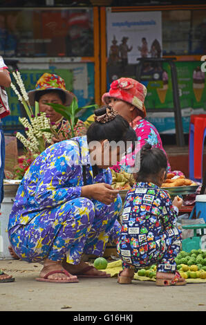 Mother and daughter in pajamas, daughter wearing a toy crown, sitting ...