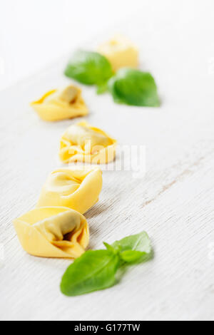 Fresh green basil leaves on a wooden board in hands Stock Photo - Alamy
