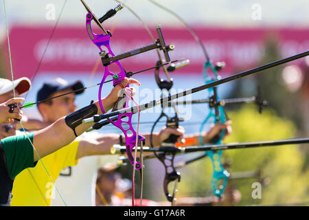 A man is shooting with a recurve bow during un open archery competition ...