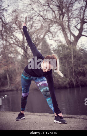 Woman bending over, touching toes, full length Stock Photo - Alamy
