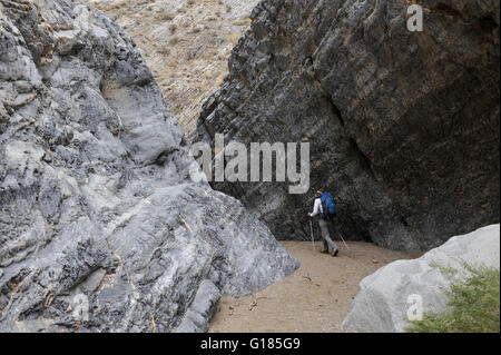 Hiker exploring rock formations, Marble Canyon, Death Valley National ...