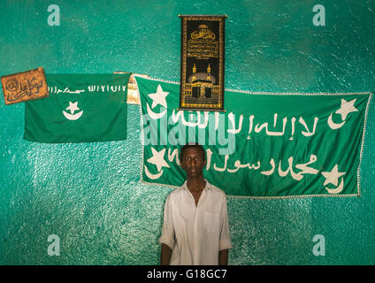 Sufi man worshipper in front of islamic red flag, Harari region, Harar ...