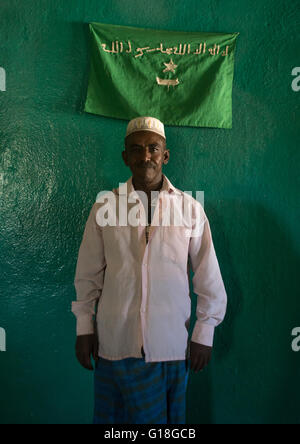 Sufi imam in front of islamic green flag, Harari region, Harar ...