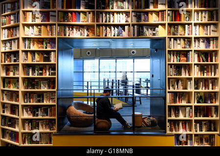 A citizen reads books at a bookstore in Gusu District, Suzhou, east ...