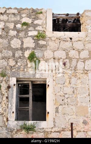 Two windows in damaged wall of an abandoned house Stock Photo - Alamy