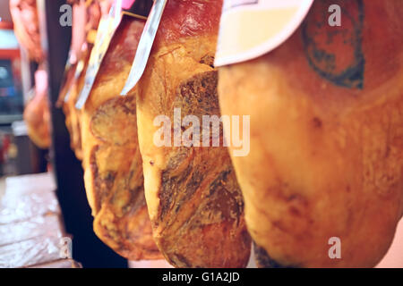 Traditional spanish jamon legs on showcase in store Stock Photo - Alamy