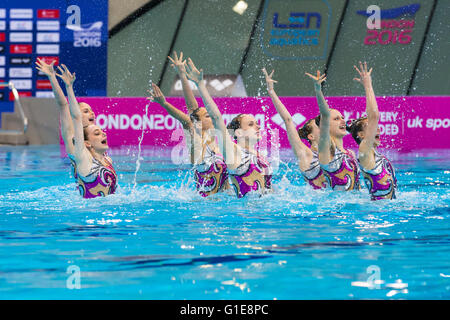 Artistic swimming team performing synchronized choreographed routine in ...