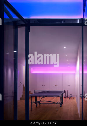 An interior shot of a room with a ping pong table, light yellow walls ...