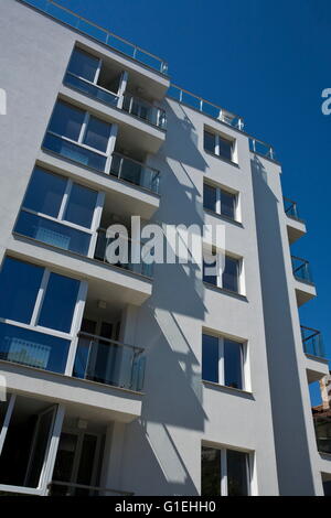 Low angle view of modern residential building under construction with ...
