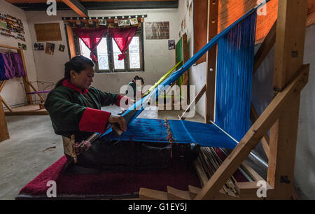 Young woman weaving tapestry at Choki traditional art school Kabesa ...