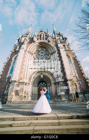 Happy gorgeous bride and stylish handsome groom on background of an ...
