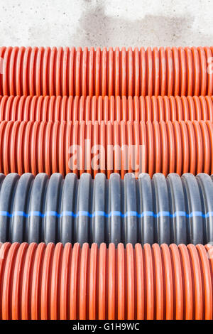 Construction orange and black plastic pipes Stock Photo - Alamy