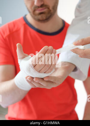 Man with an injured hand after accident at work in the carpentry ...