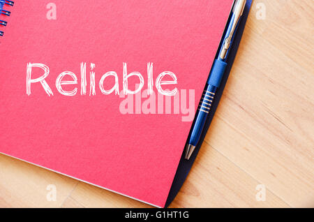 Reliable text concept write on notebook Stock Photo - Alamy