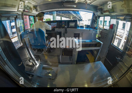 A Japanese train driver in a train cockpit Stock Photo - Alamy