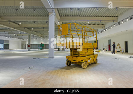 Scissor lift platform inside of industrial building Stock Photo - Alamy