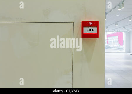 Red fire alarm panel box is on the wall, to smash glass and press ...