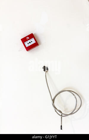 Red fire alarm panel box is on the wall, to smash glass and press ...