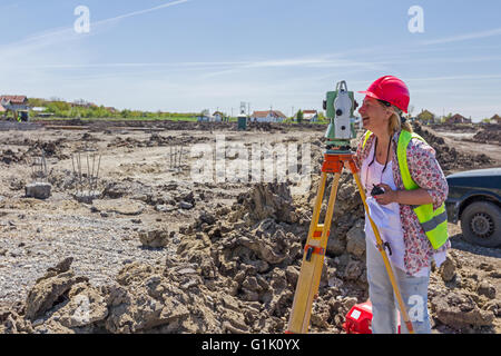 Female civil engineering surveyor with theodolite Stock Photo - Alamy