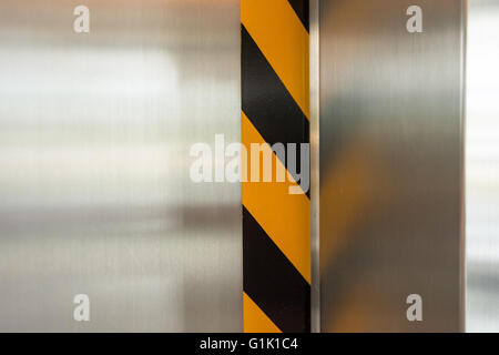 black and yellow lined sticker edge warning on elevator door Stock ...