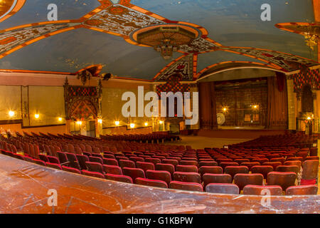 Interior of 1920's era movie theater in decay with empty seats and open ...