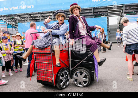 Men dressed as old ladies riding on Segways done up as shopping baskets ...