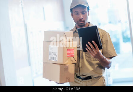 Delivery man using digital tablet in delivery van Stock Photo - Alamy