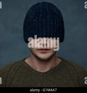 Caucasian man wearing beanie hat over eyes Stock Photo - Alamy