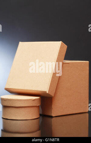 Blank cardboard boxes on dark background Stock Photo - Alamy